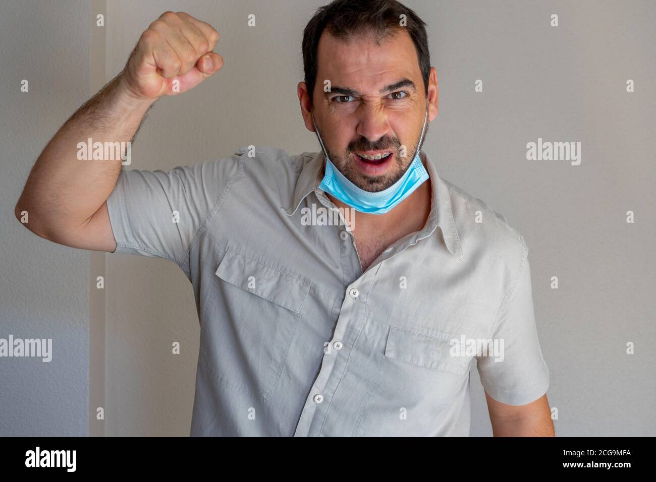 Portrait of worried bearded man wearing a mask to protest himself from ...