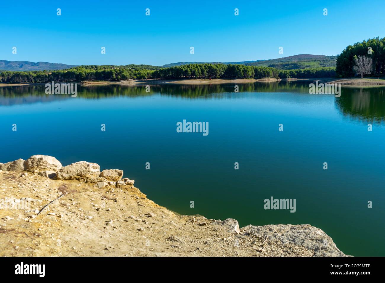 Reservoir landscape with nice reflections of the forest in the water on ...