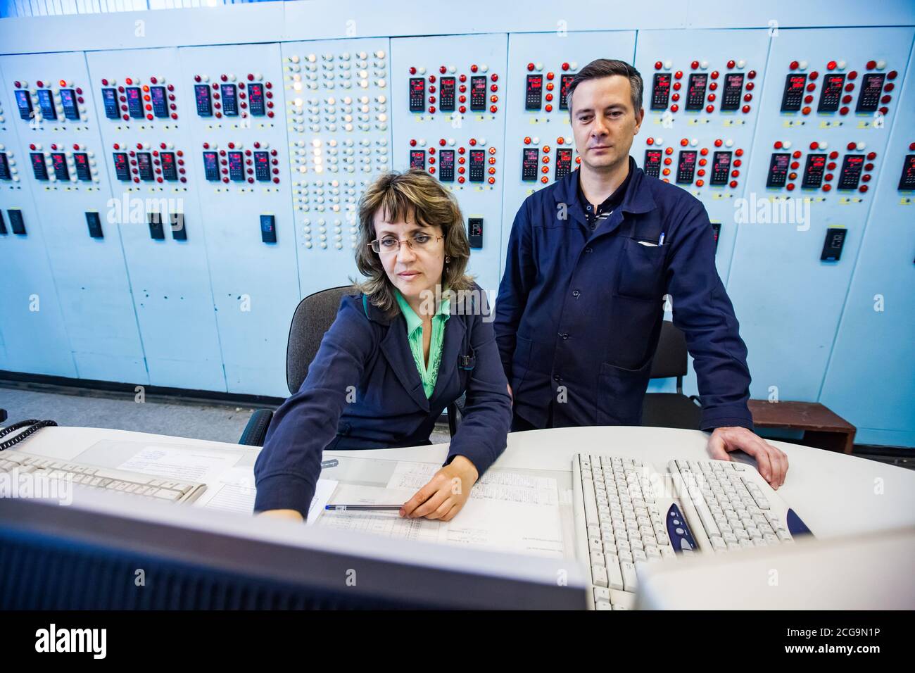 Control room of titanium metallurgical plant. Two engineers on their ...
