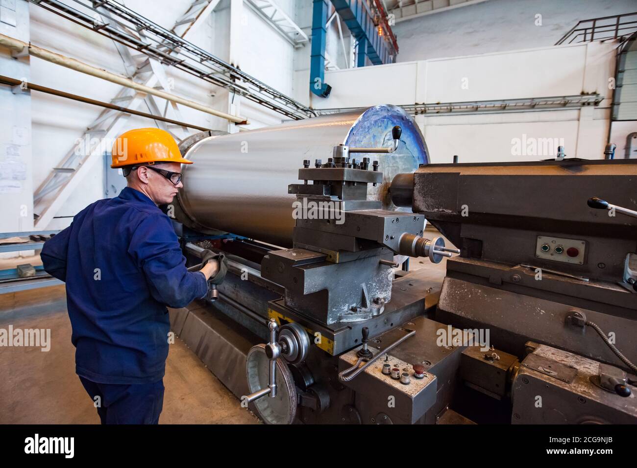 Big metal titanium cylinder after mechanical works on turning lathe ...