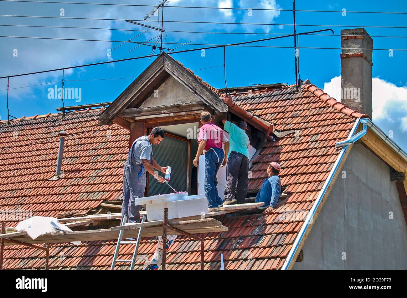 Zrenjanin, Serbia, July 17, 2013. A group of craftsmen is working on ...