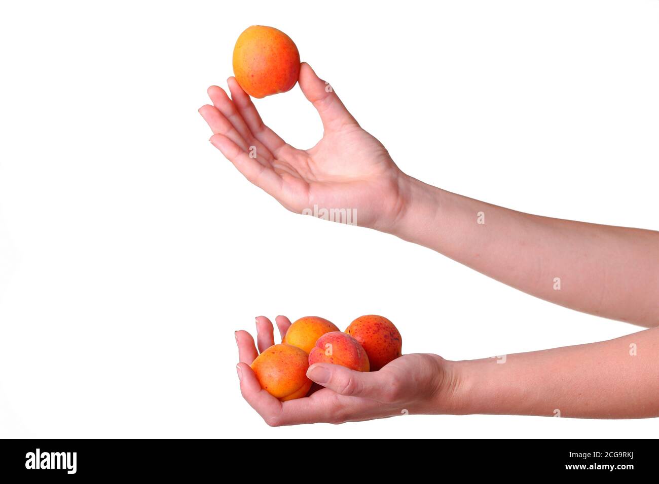 Female hand with tasty apricot on white background. Cream for hands and ...