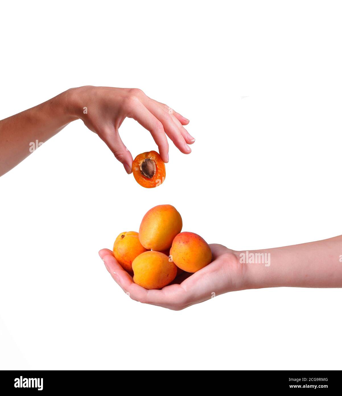 Female hand with tasty apricot on white background. Cream for hands and ...