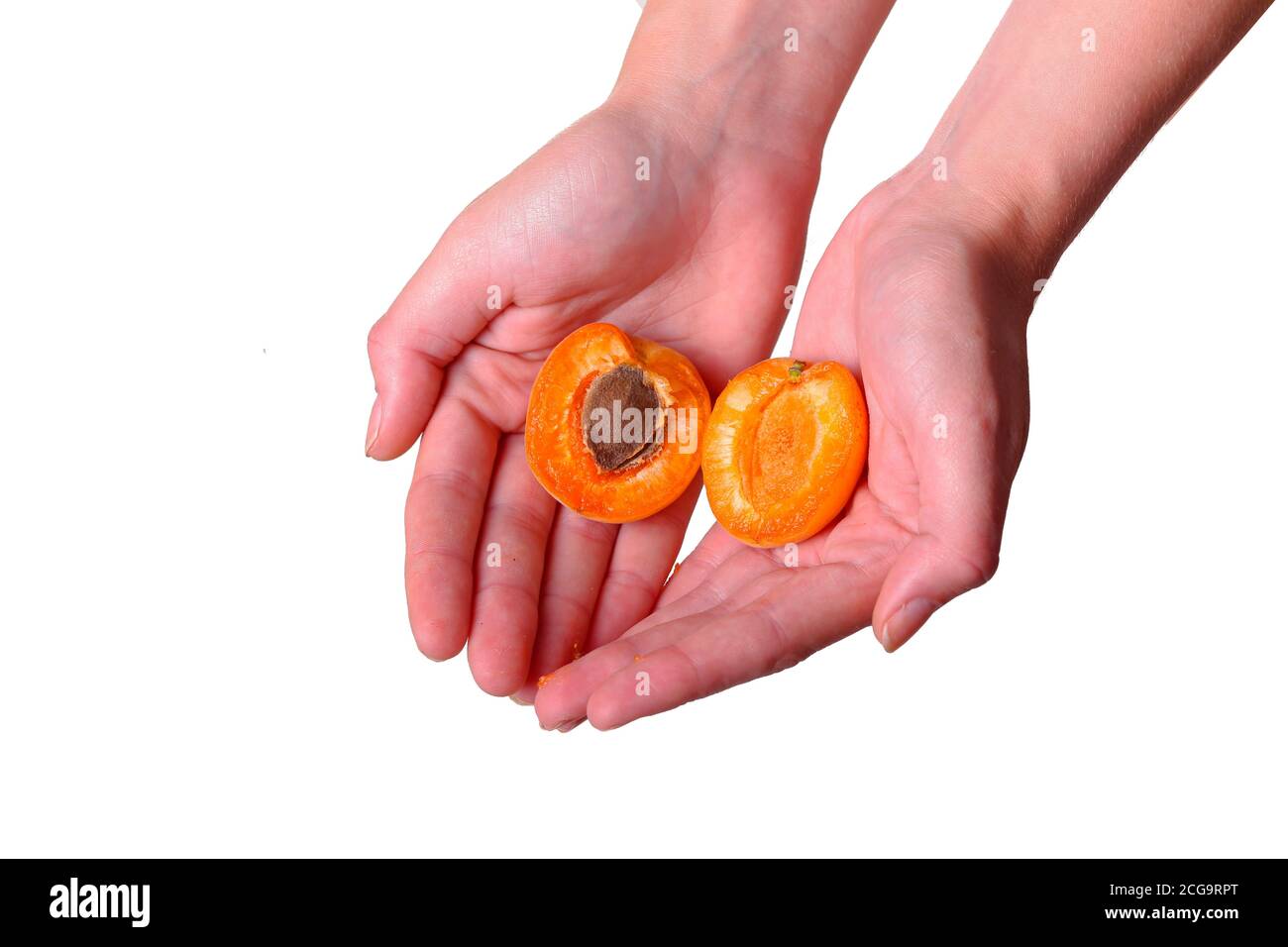 Female hand with tasty apricot on white background. Cream for hands and ...