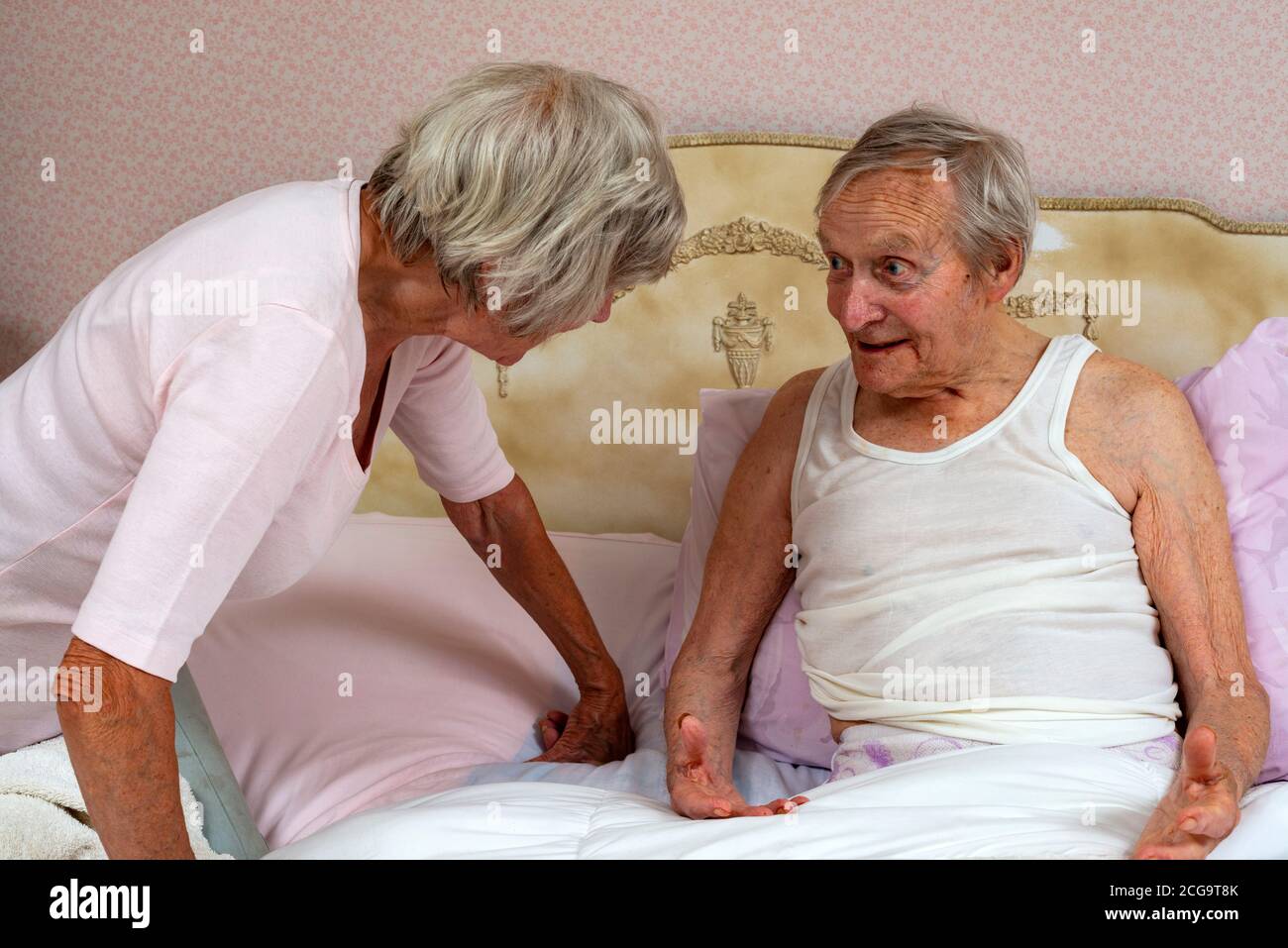 Elderly couple in bedroom Stock Photo - Alamy