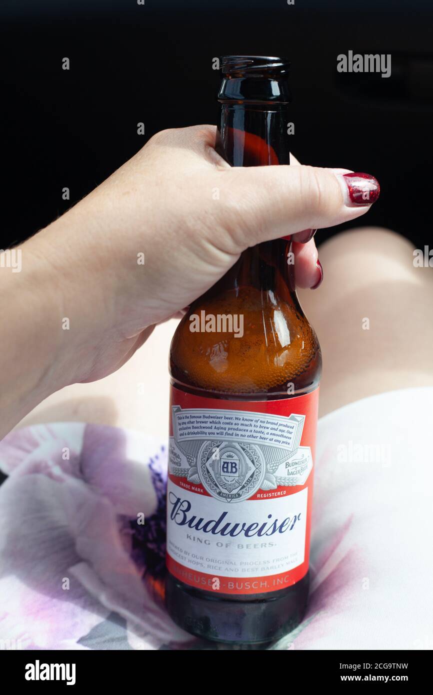 High resolution close-up of female passengers hand holding a bottle of ...