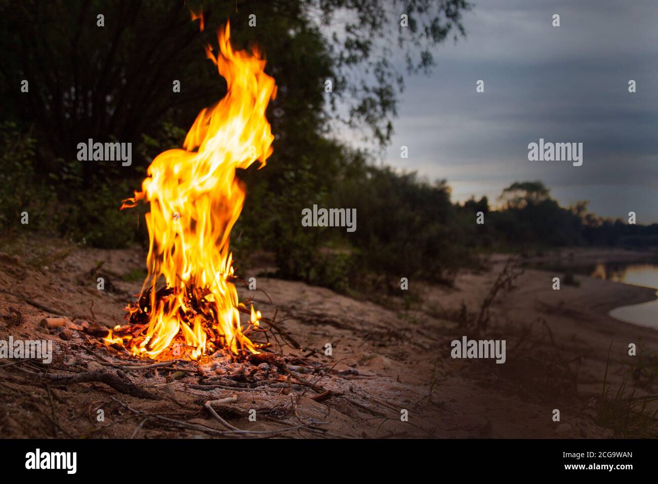 Fire on a sandy beach big flame. night sky. outdoor recreation concept ...