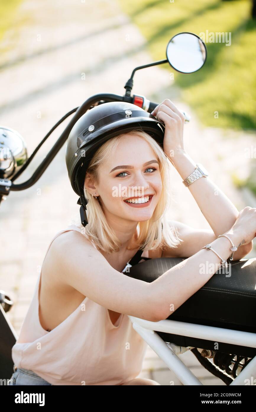 Beautiful female biker of european appearance with biking helmet on ...