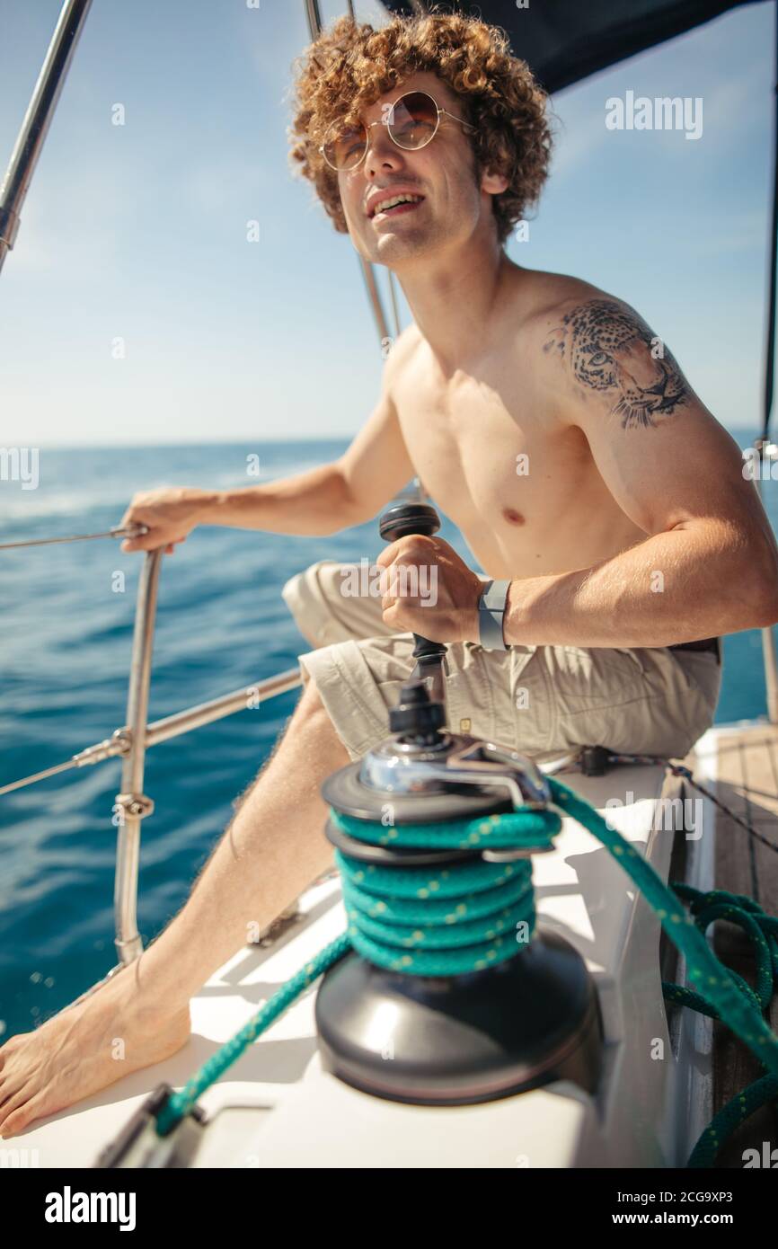 sailing, vacation, tourism, travel and people concept - young handsome ...