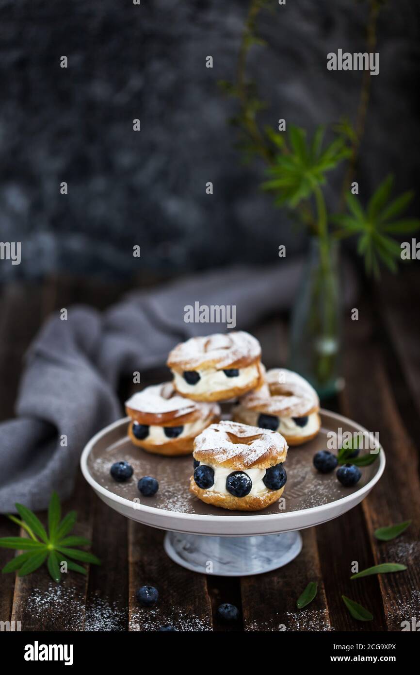 Cream puff rings (choux pastry) decorated with fresh blueberries Stock ...
