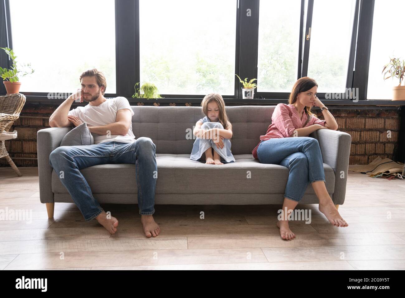 Little girl between arguing parents at home Stock Photo - Alamy