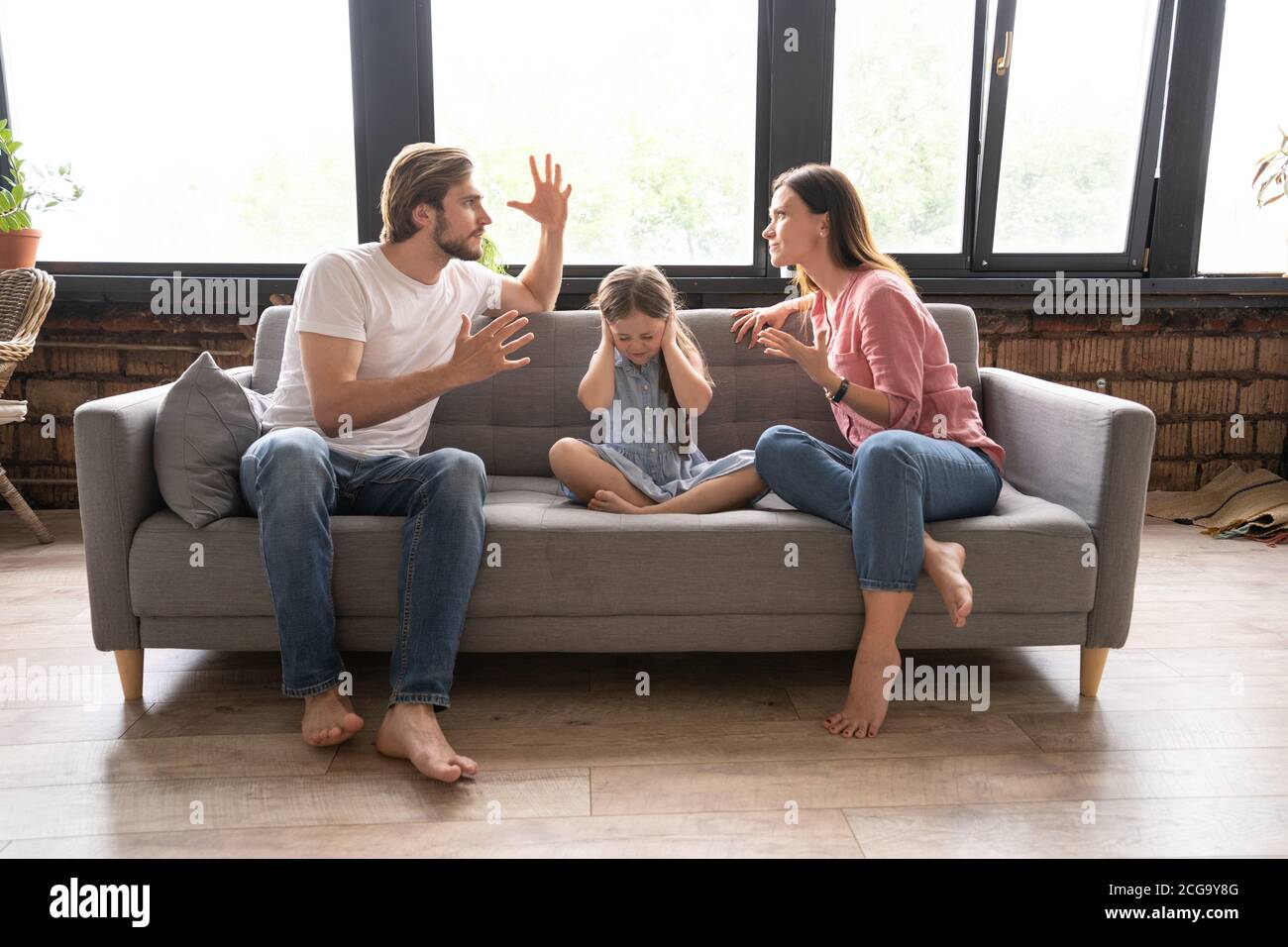 Little girl between arguing parents at home Stock Photo - Alamy