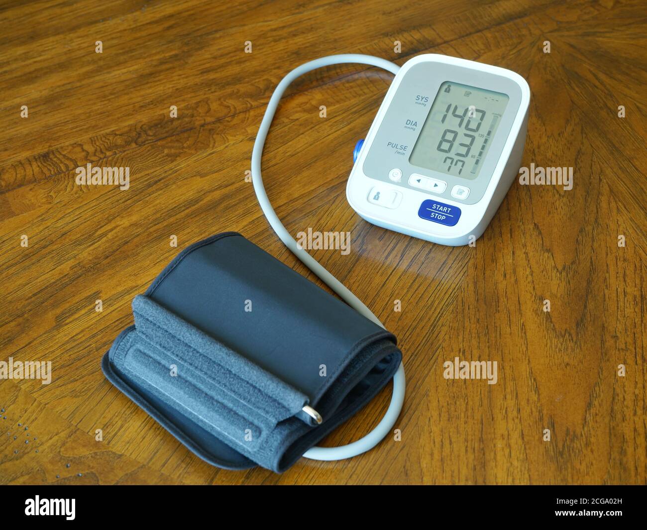 Automatic digital blood pressure monitor on wood table Stock Photo - Alamy