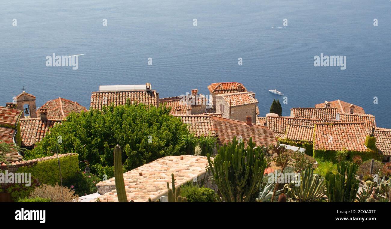 Aerial view on "Eze" city terracotta rooftops and blue mediterranean ...