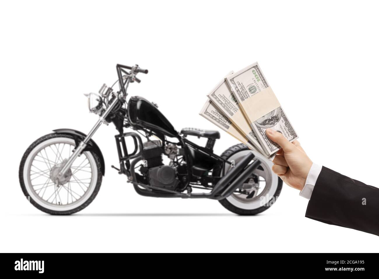 Male hand in front of a custom choper motorbike holding stacks of us ...