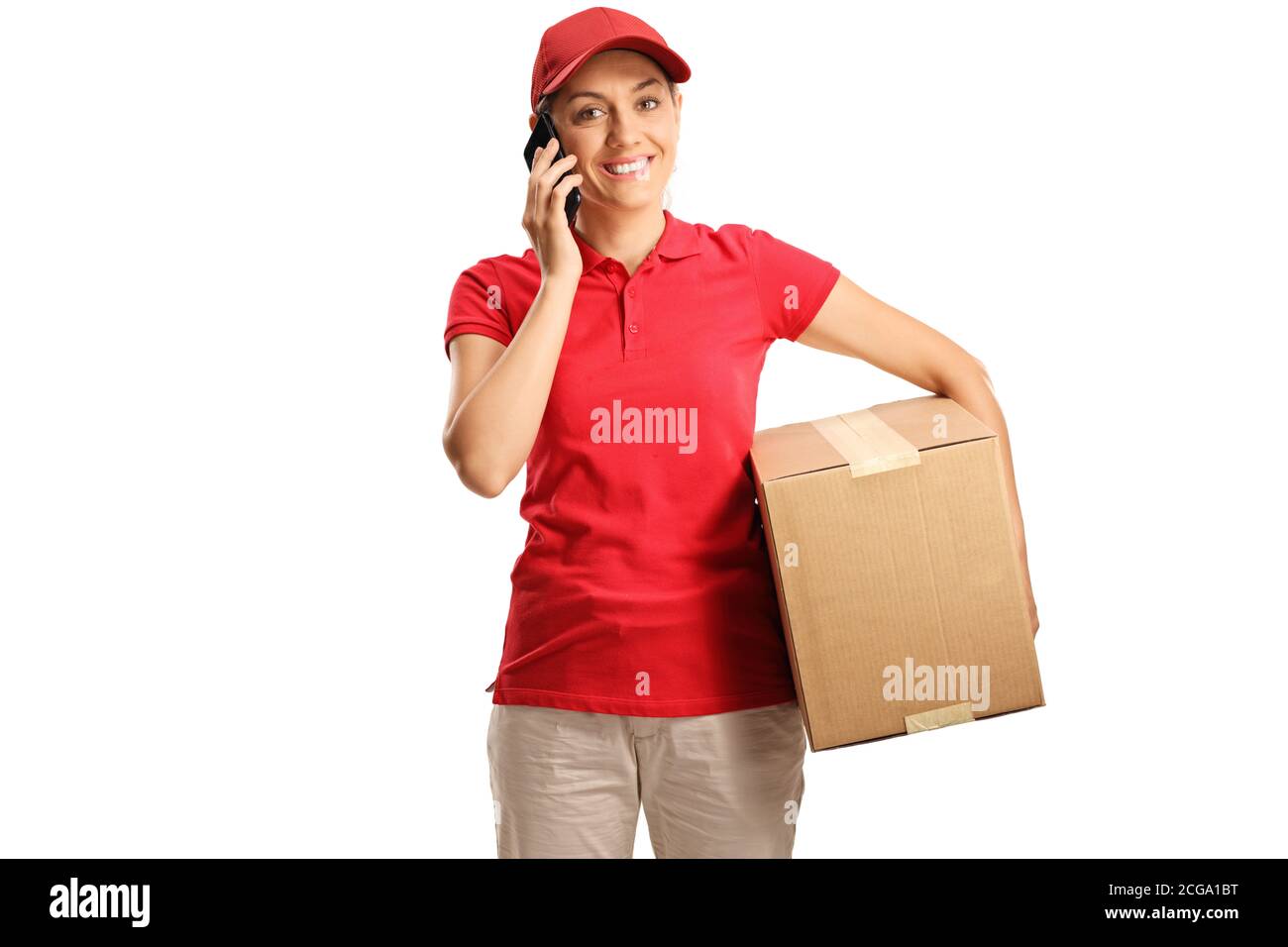 Delivery woman holding a cardboard box and making a phone call isolated ...