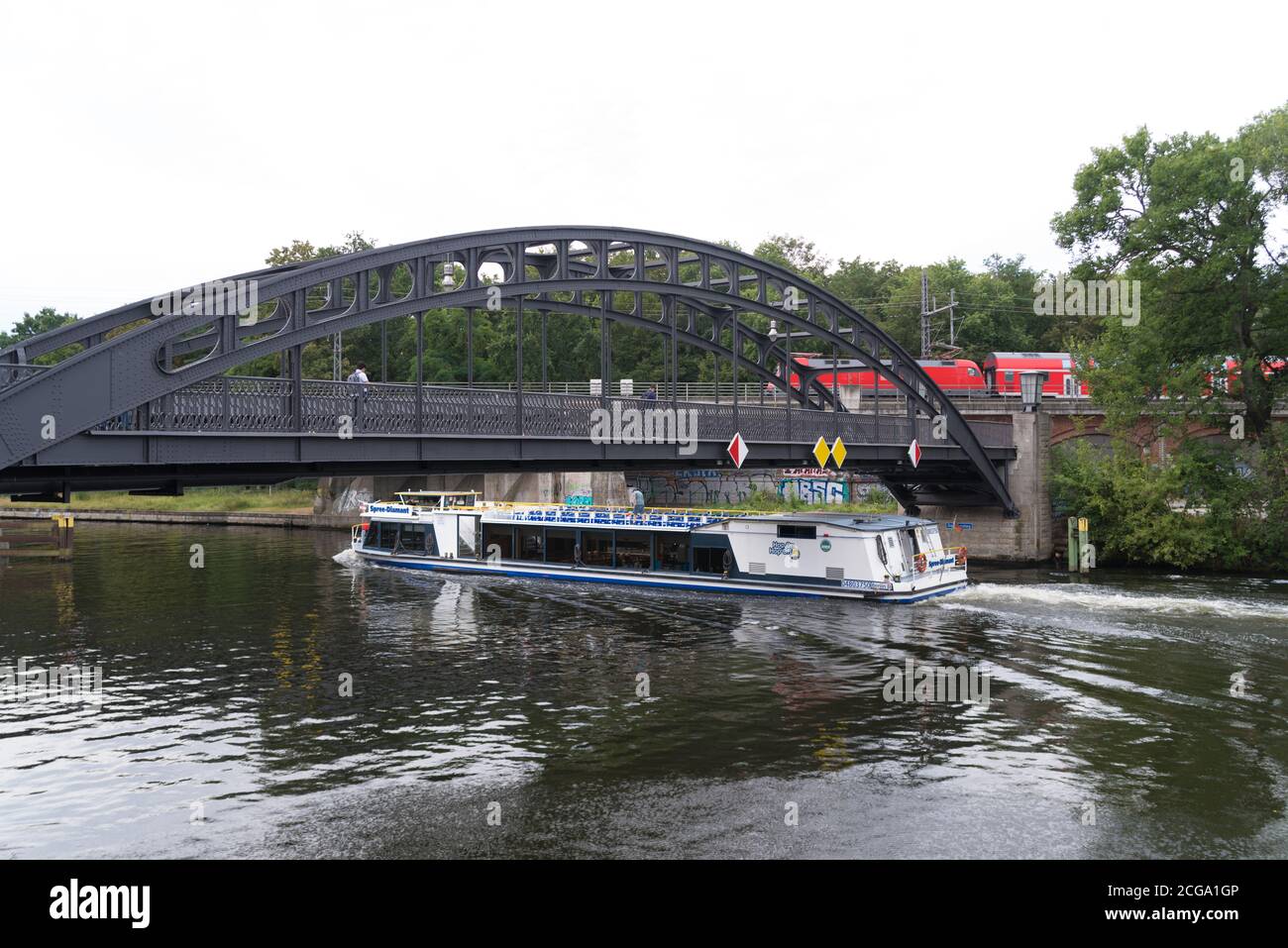 BERLIN, GERMANY - AUGUST 29, 2020: Passenger boat passing a railroad ...
