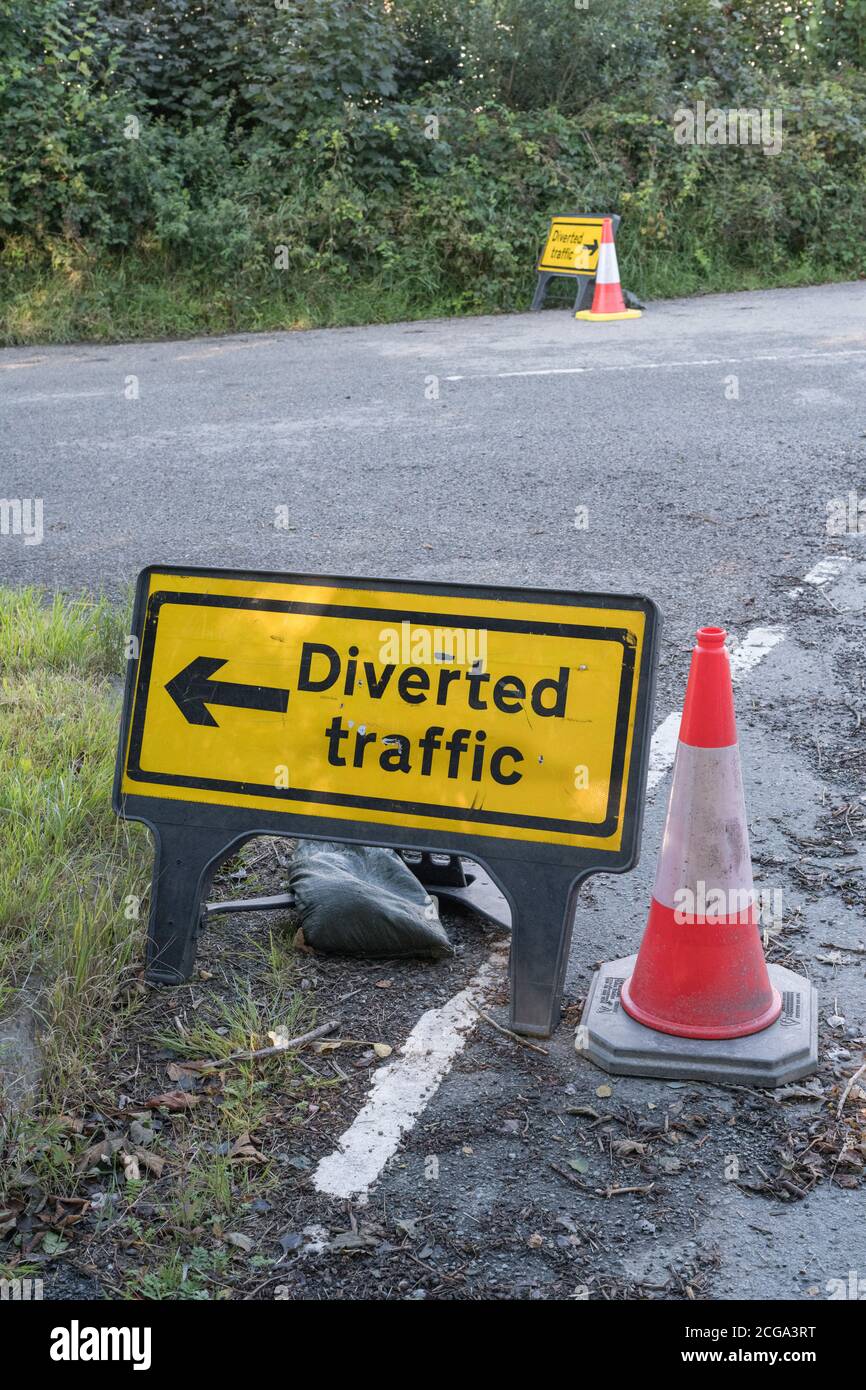 UK road transport system. Orange and white road cone & diverted traffic ...