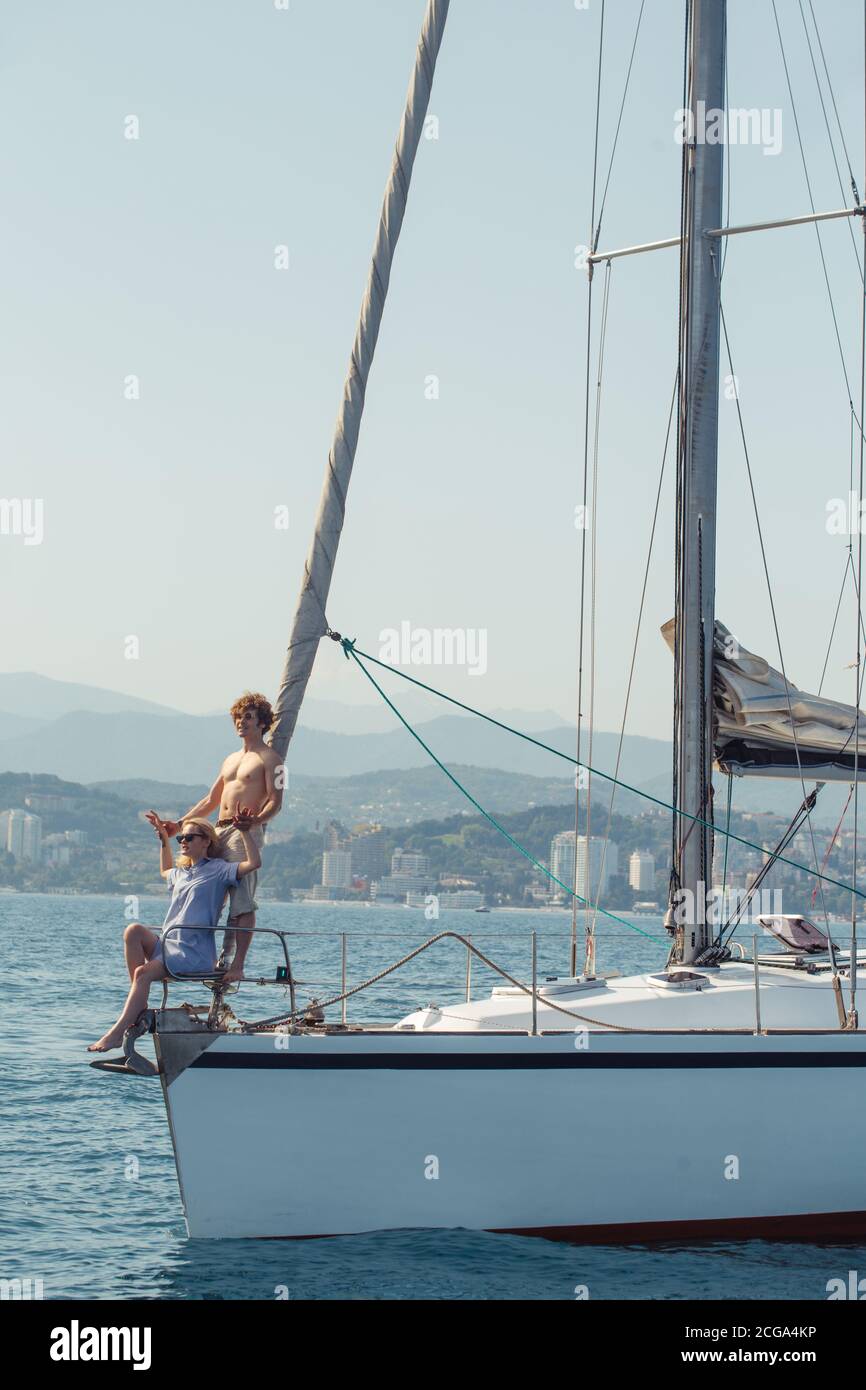 Floating yacht with sails down in calm sea. A boat lowered the sails ...