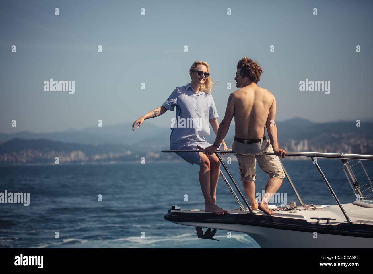 Romantic vacation and luxury travel. Young loving couple sitting on the ...