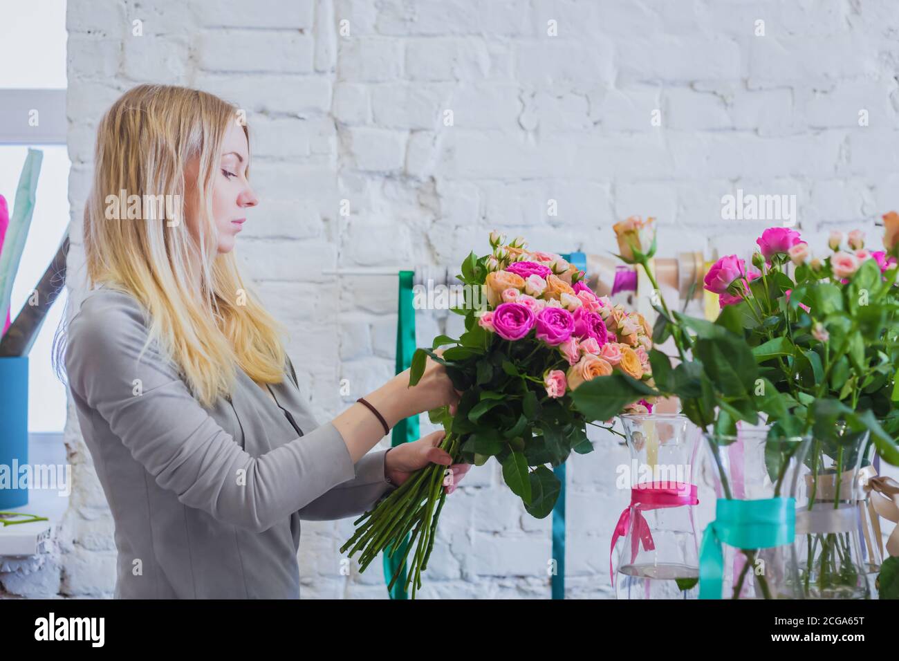 Professional woman floral artist, florist making beautiful fresh ...