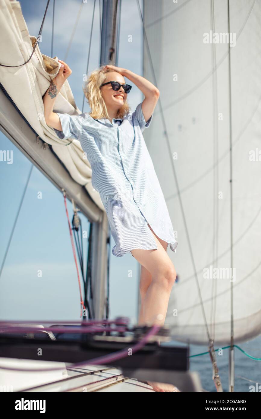 Portrait of a young woman standing on yacht hi-res stock photography ...