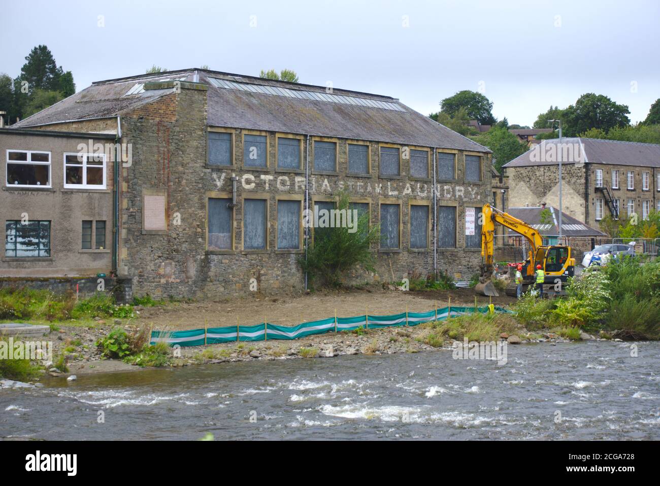 Workmen and digger outside the former Victoria Steam Laundry ...