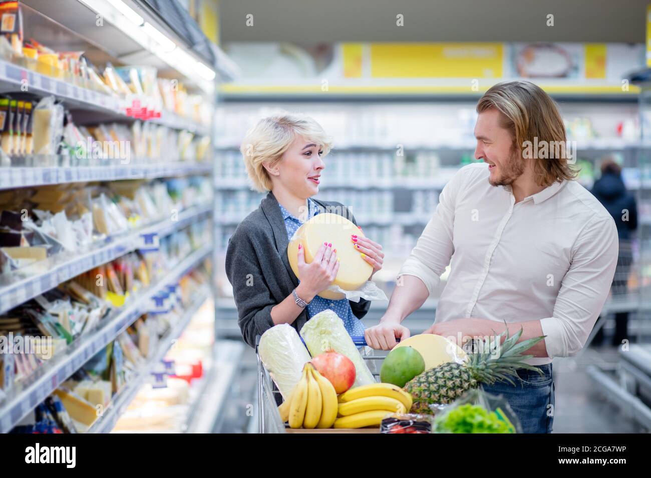 Consumerism concept. Ordinary aucasian family going among shelves with ...