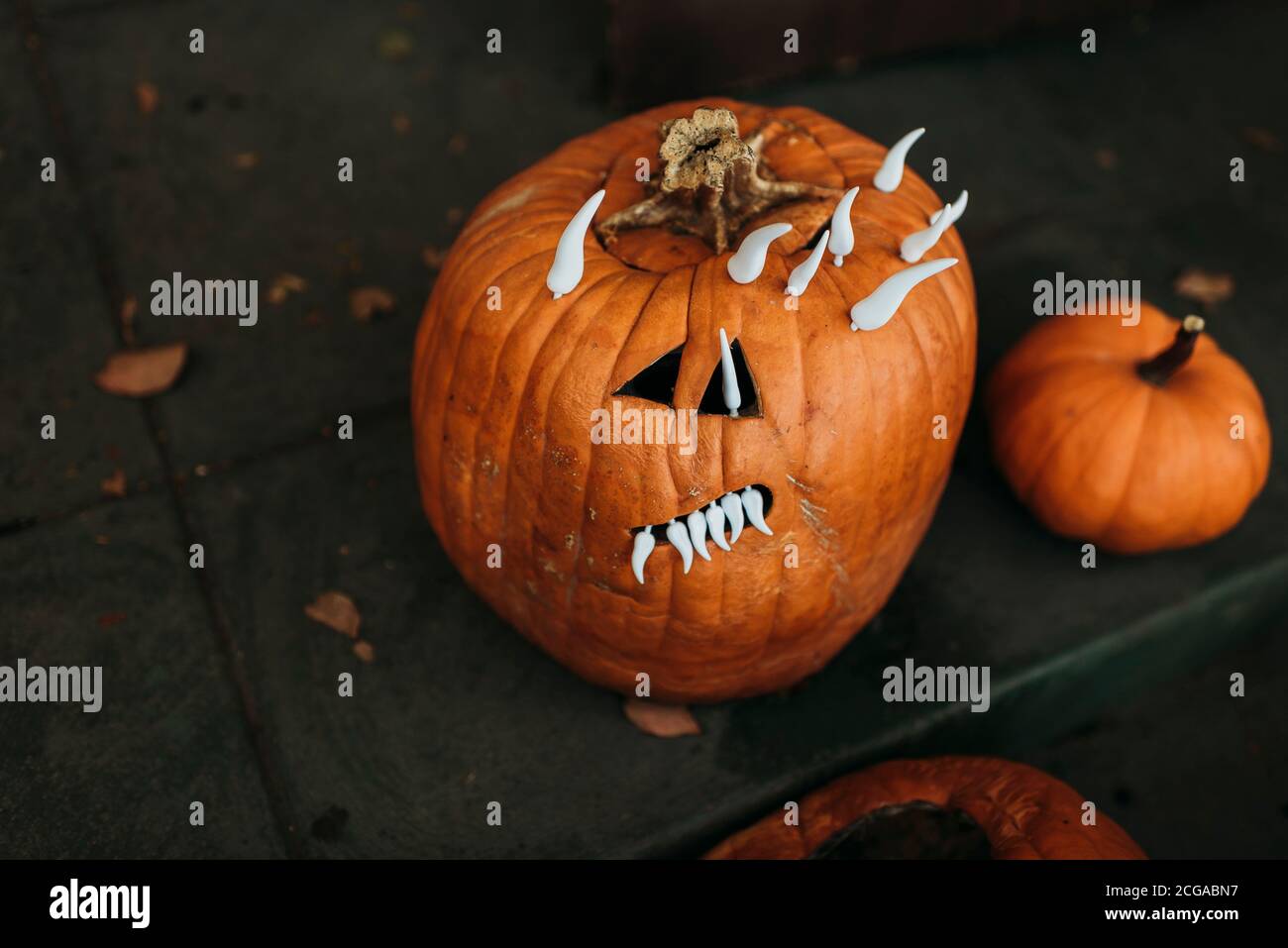 Close up of spooky carved pumpkin with teeth sitting on porch Stock ...