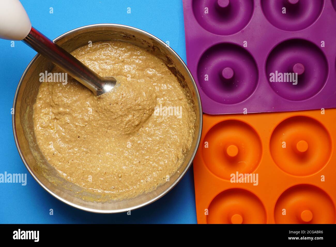 top view of cake mix in bowl with mixer and molds beside. cooking ...