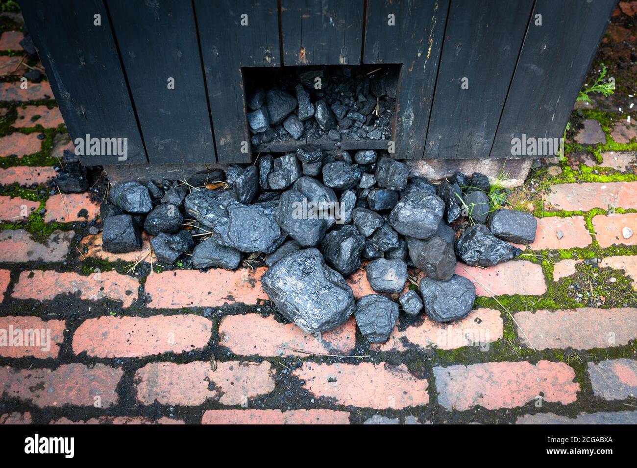 Coal spilling out from a coal shed Stock Photo - Alamy