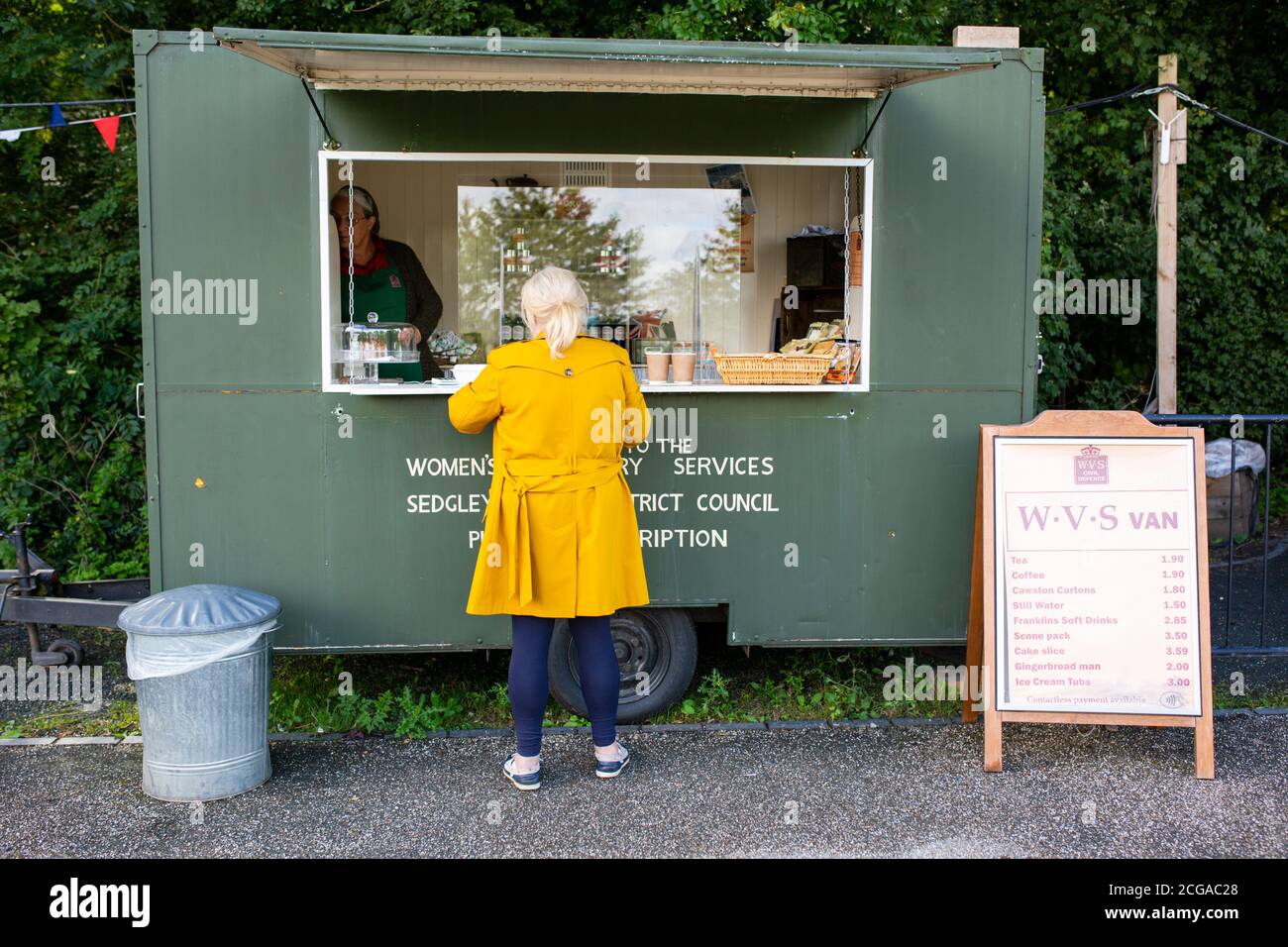 Woman buying a cup of tea from a WWII Womens Voluntary Service van ...