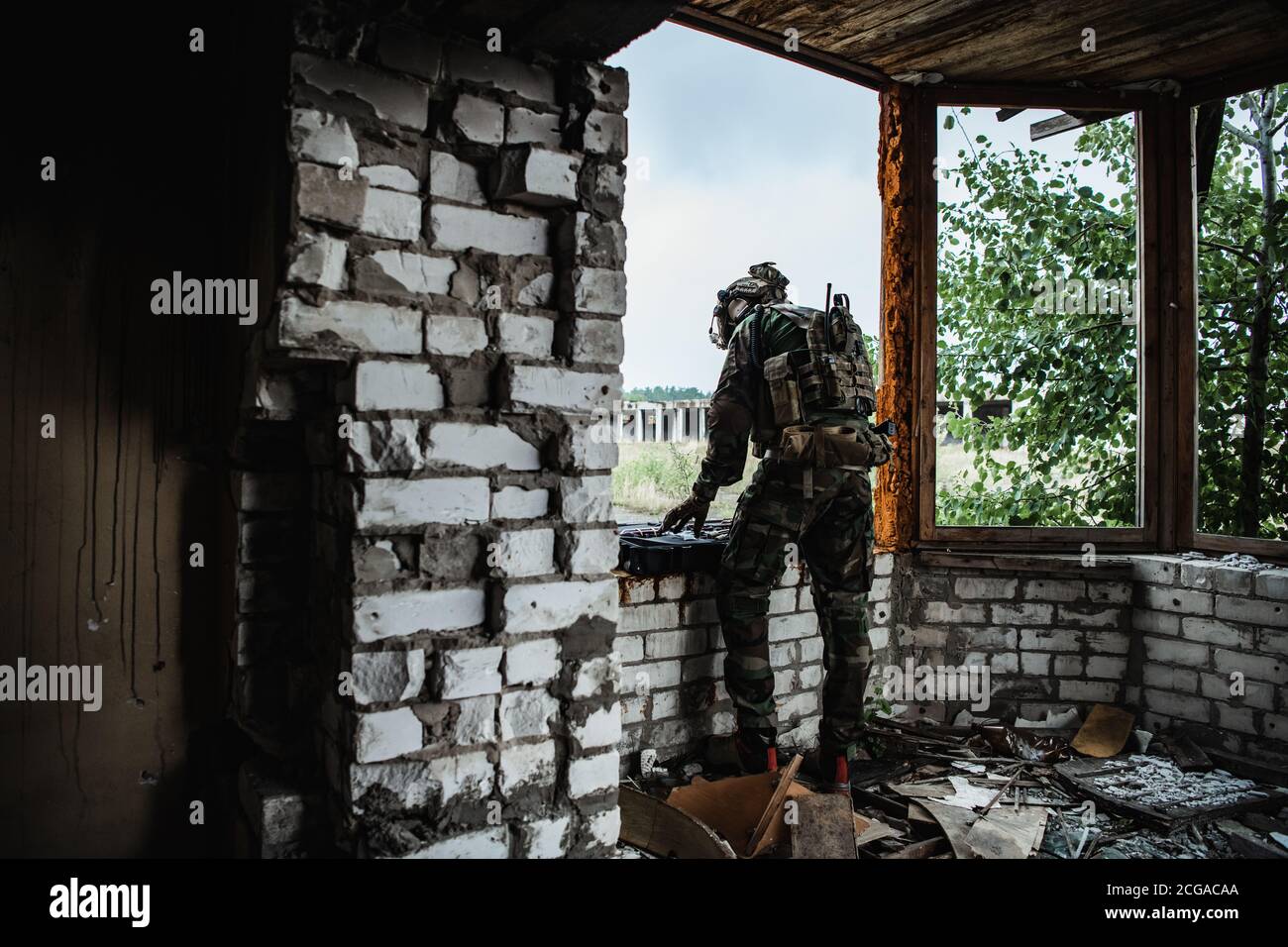 Military man preparing equipment of firearms to the mission. Pulls out ...