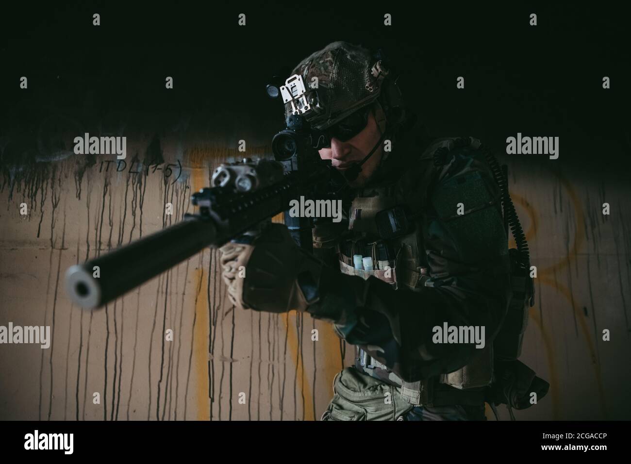 Soldier in full US MARSOC equipment entering abandoned building, aiming ...