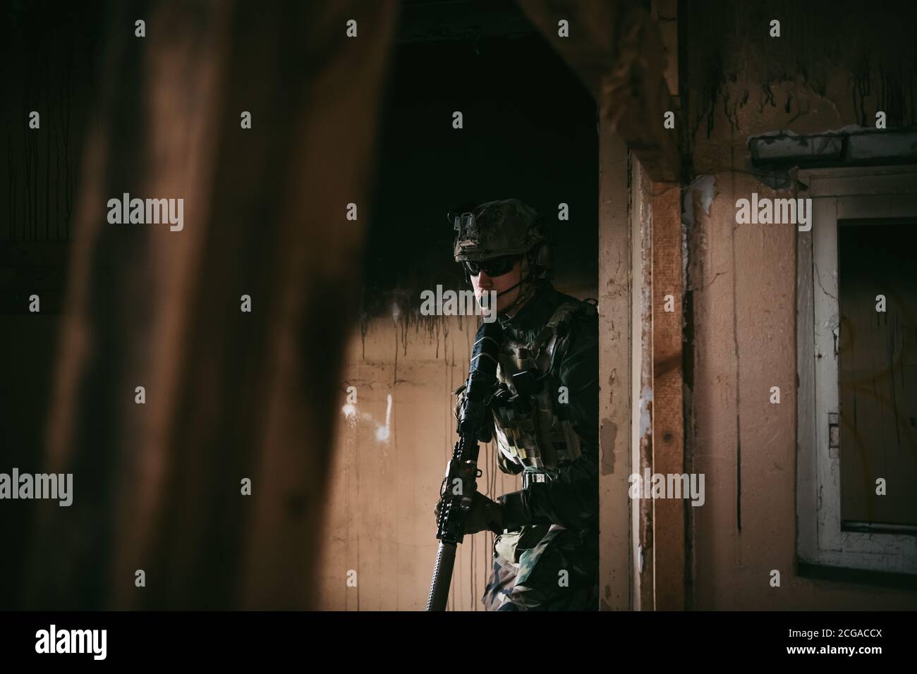 Soldier in full US MARSOC equipment entering abandoned building, aiming ...