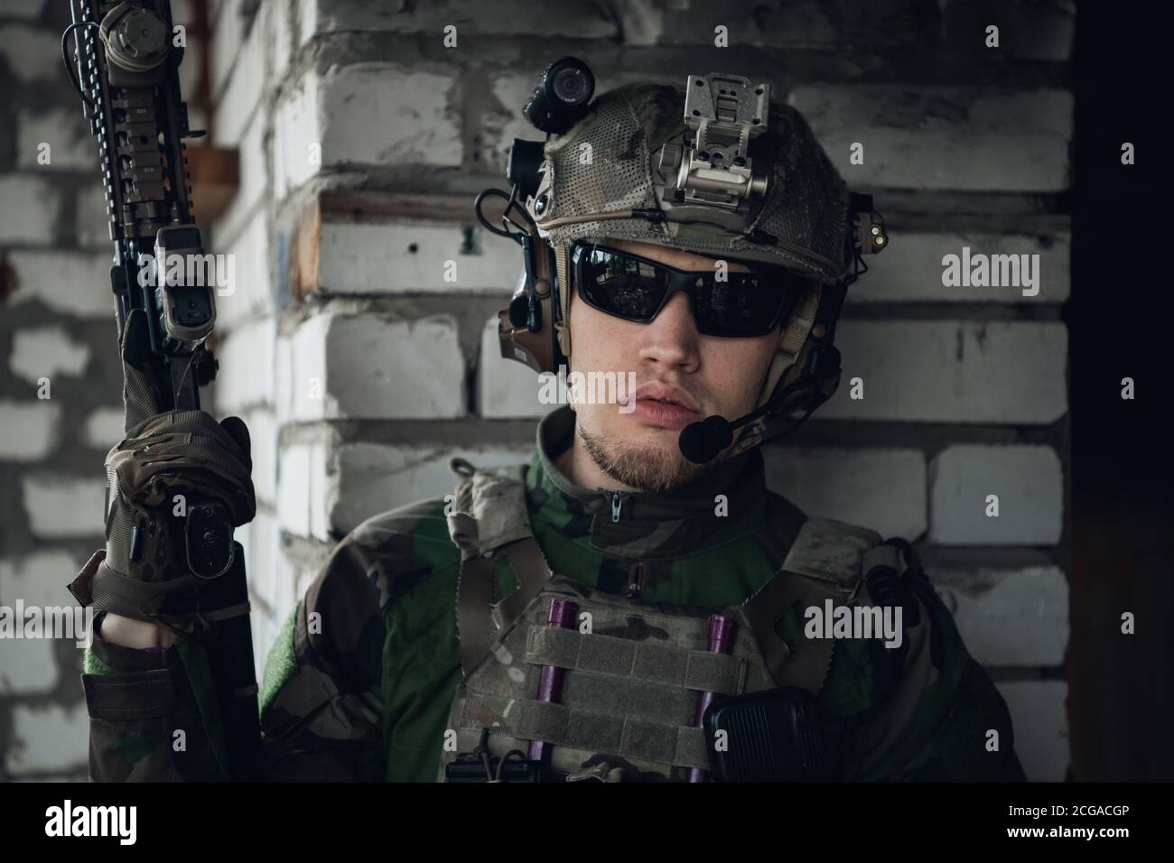 Close-up of a professional fully equipped soldier looking at camera ...