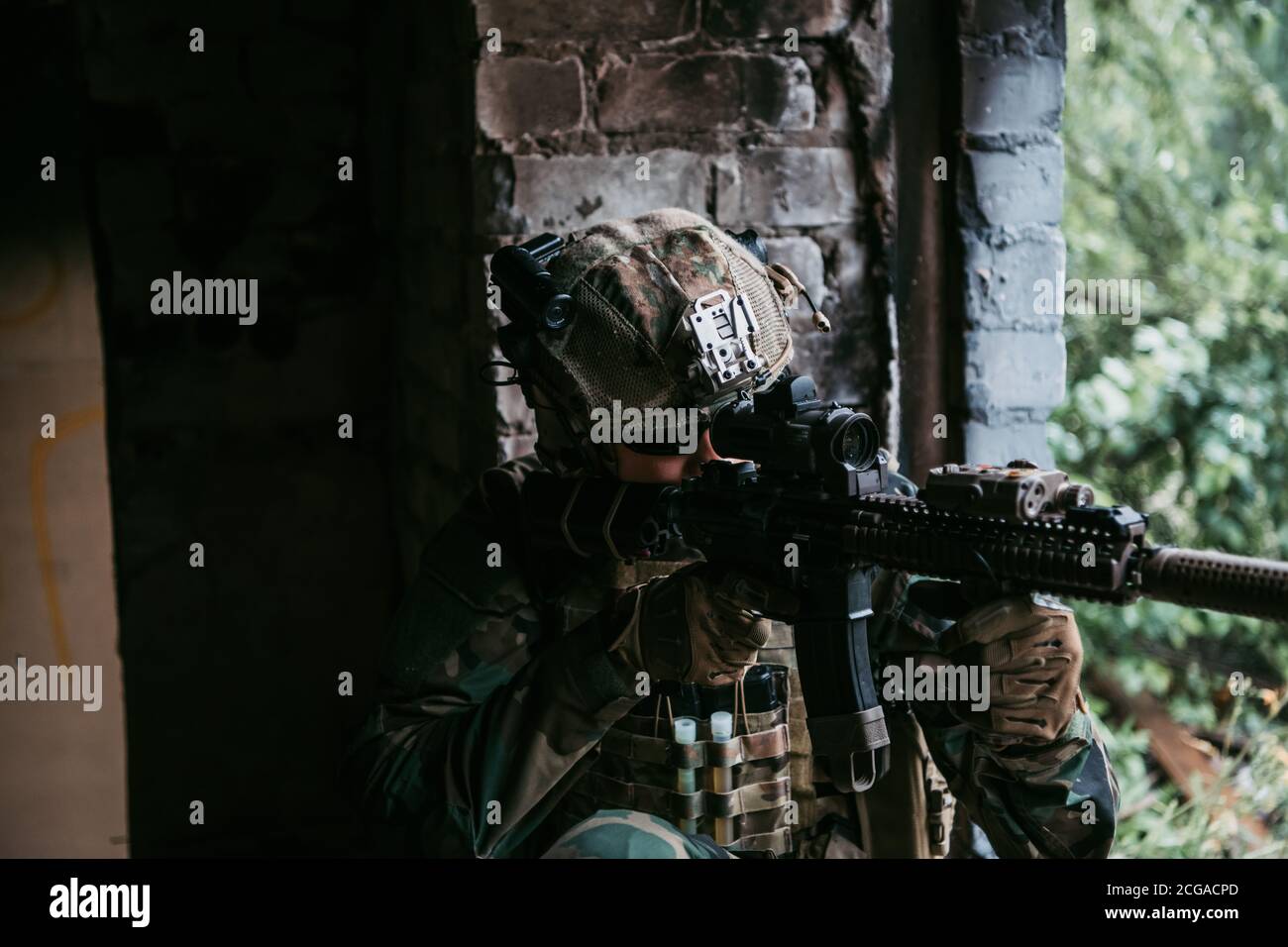 Soldier in combat. Urban combat training, soldier entering abandoned ...