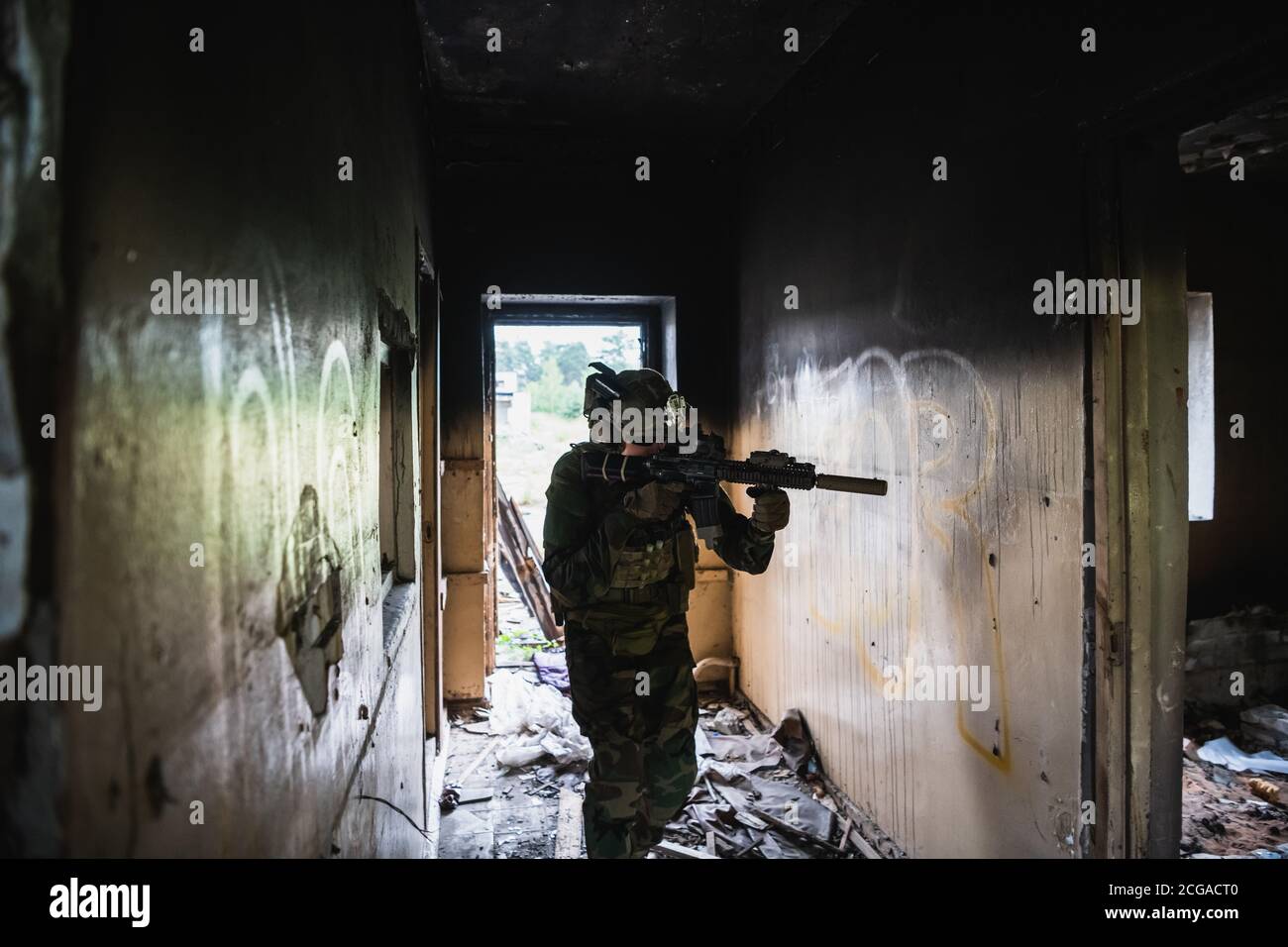 Soldier in combat. Urban combat training, soldier entering abandoned ...