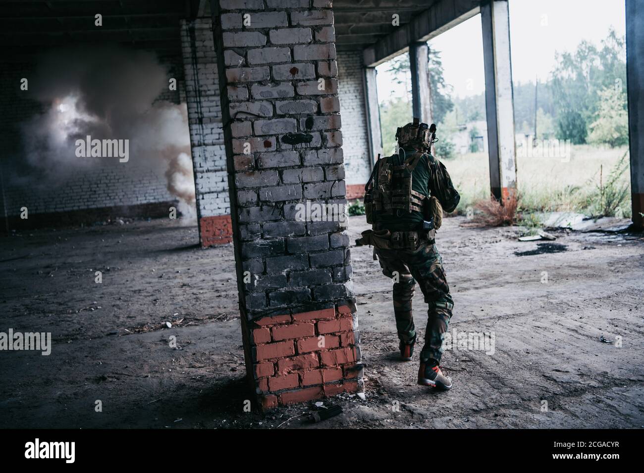 Soldier in combat. Urban combat training, soldier entering abandoned ...