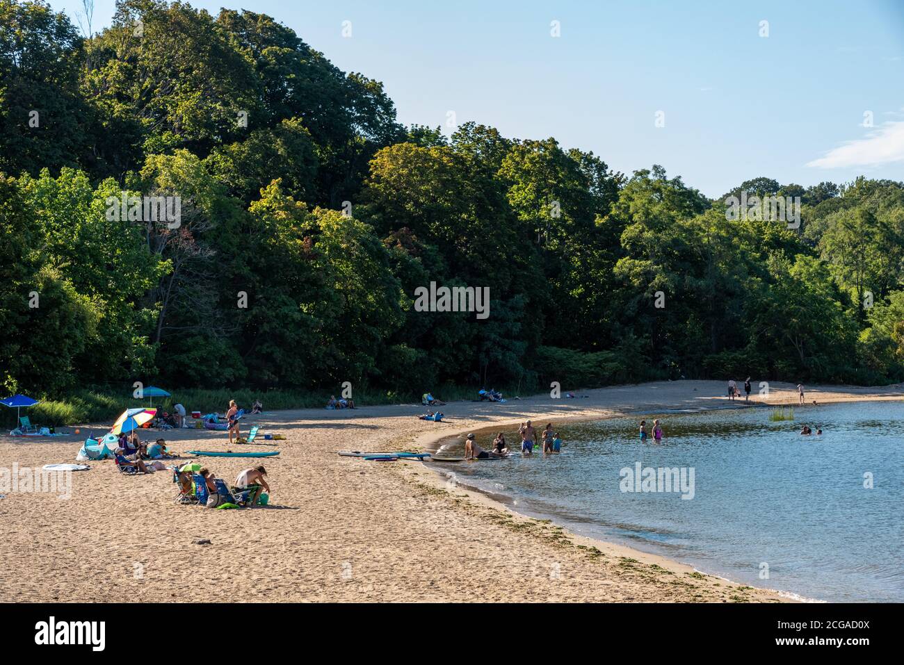 OYSTER BAY, NY USA - AUGUST 23 2020: Bathers in the afternoon sun on ...