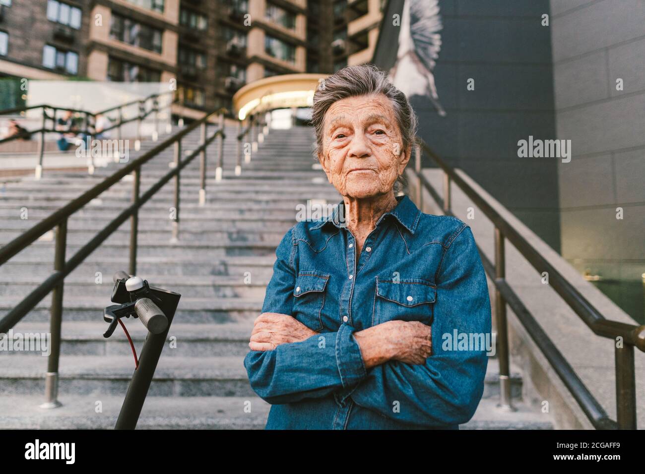 Old woman near scooter. Grandmother progressive woman. Senior having ...
