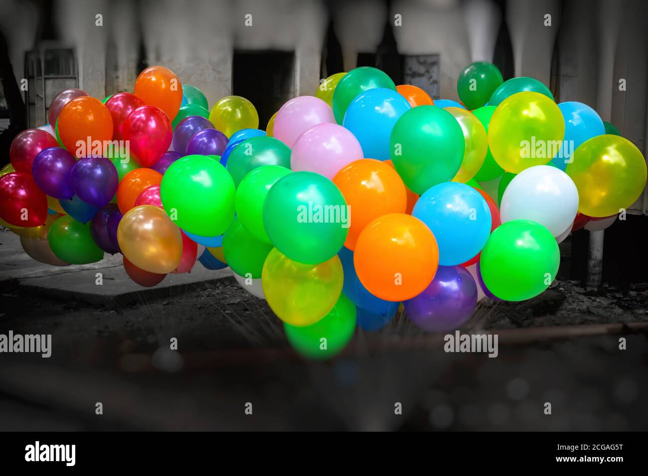 A bunch of colorful gas-filled balloons on dark background Stock Photo ...