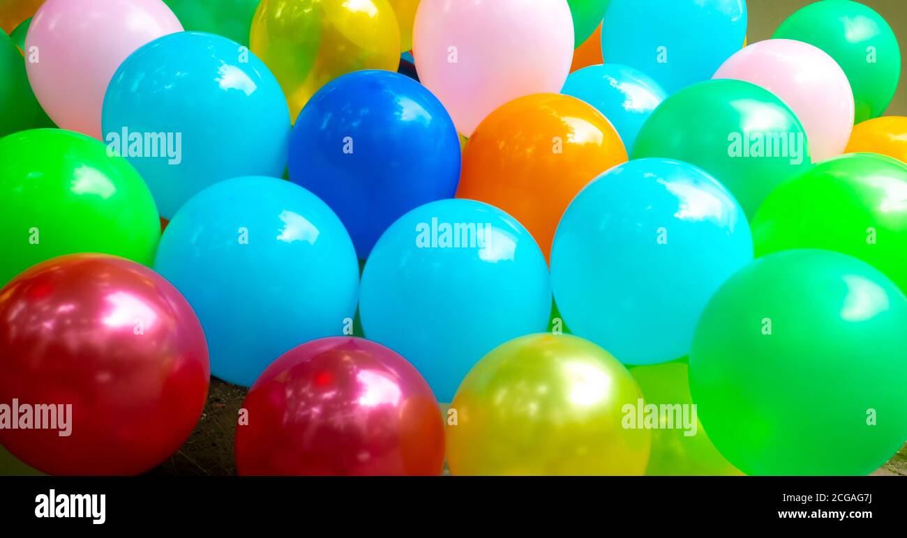 Light blue and green color-based colorful gas-filled balloons close-up ...