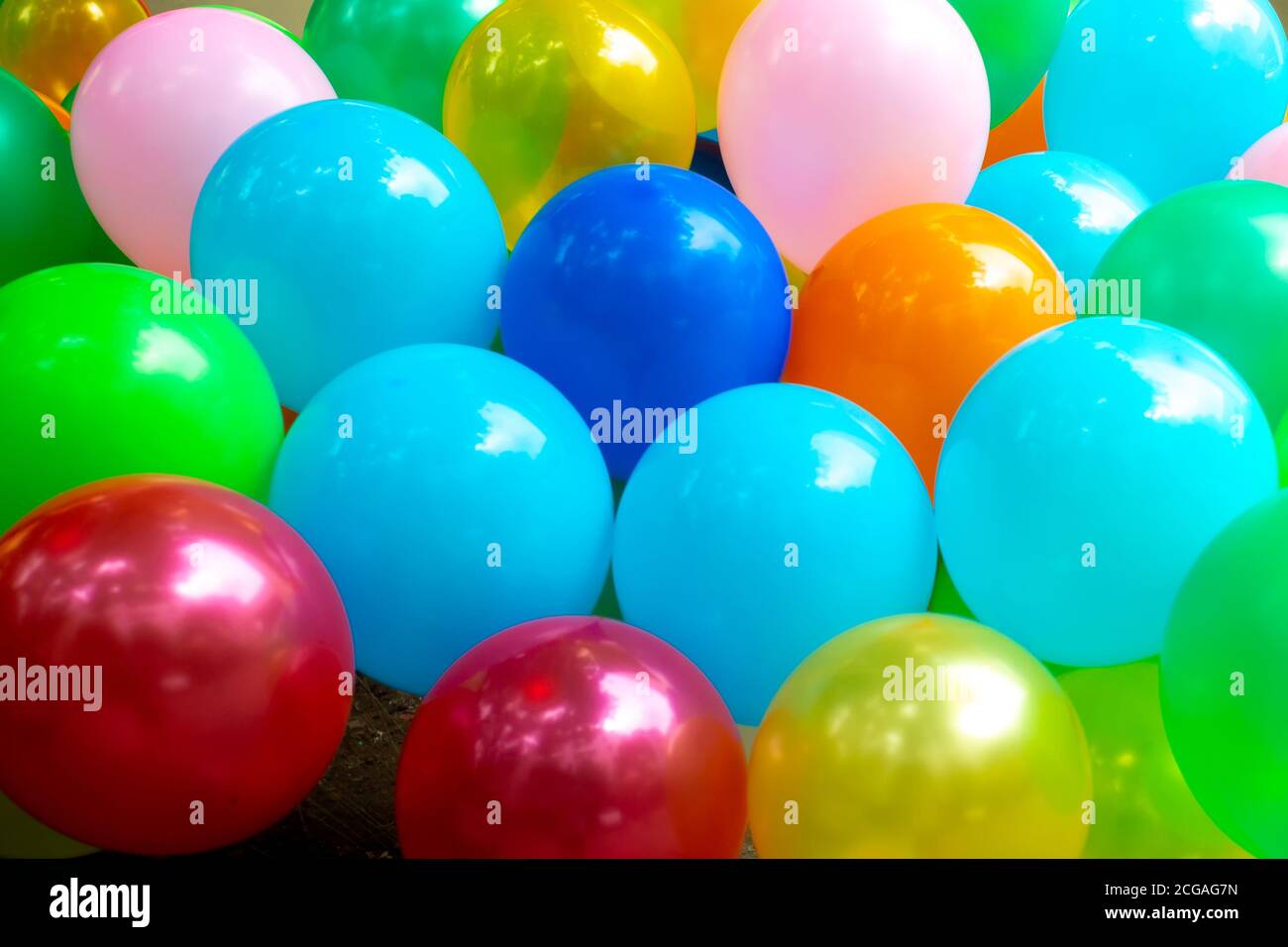Light blue and green color-based colorful gas-filled balloons close-up ...