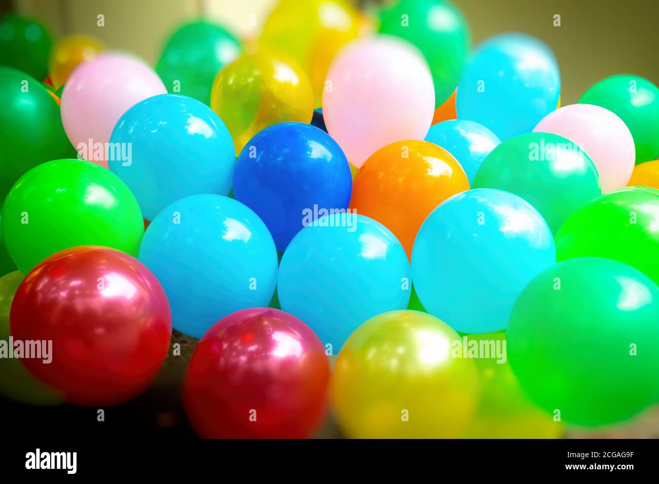 Light blue and green color-based colorful gas-filled balloons close-up ...