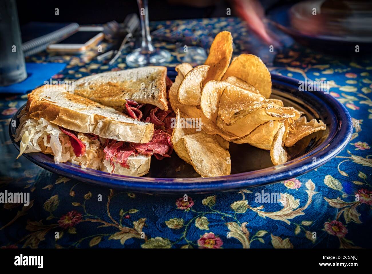 A rueben sandwich on a plate with potato chips Stock Photo - Alamy