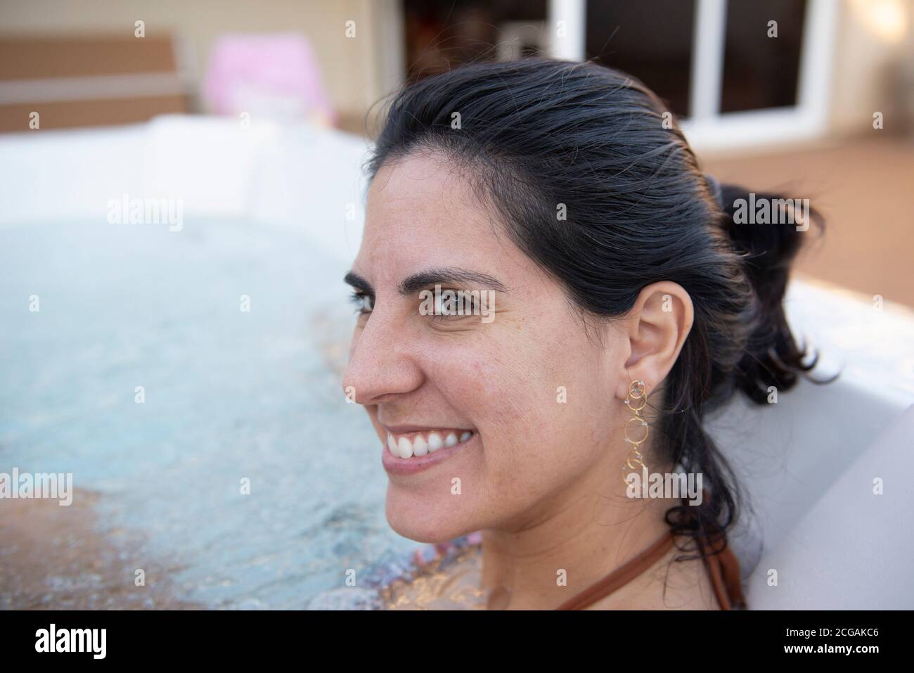 Beautiful woman smiling wearing bikini in a hydromassage bath. Concept ...