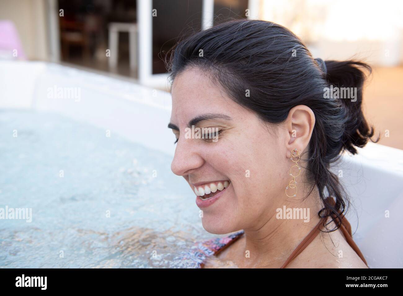 Beautiful woman smiling wearing bikini in a hydromassage bath. Concept ...