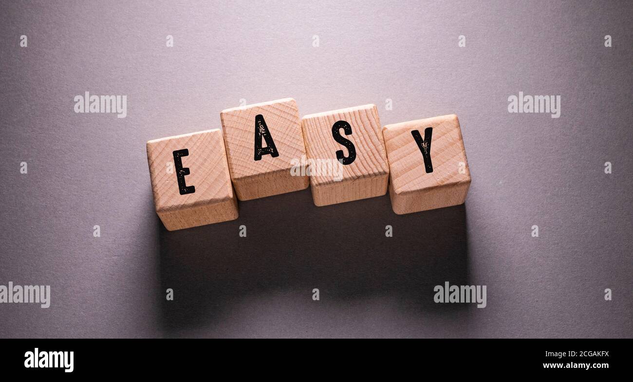Easy Word Written on Wooden Cubes Stock Photo - Alamy