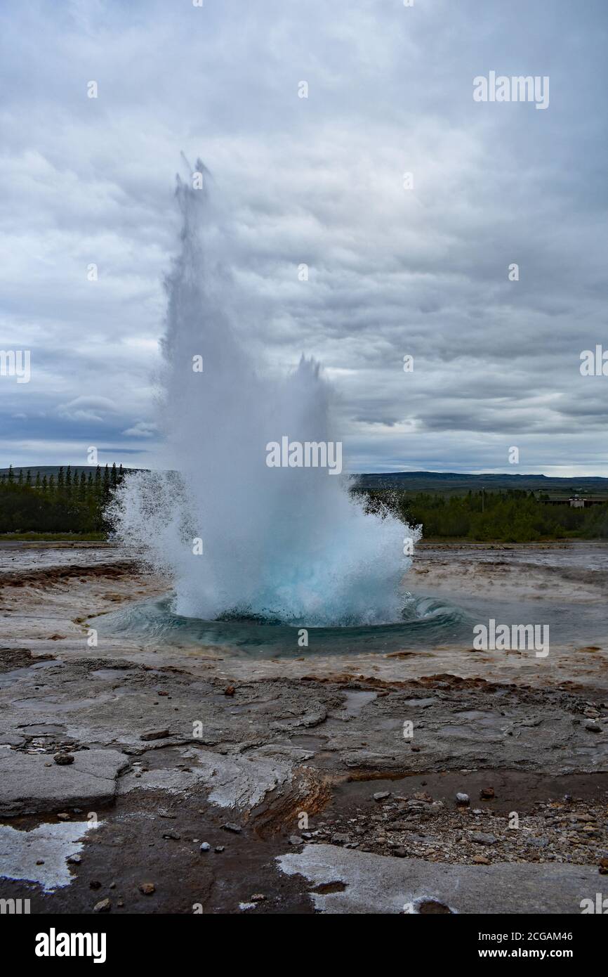 Strokkur Geyser as it begins to erupt. The steam and water has just ...